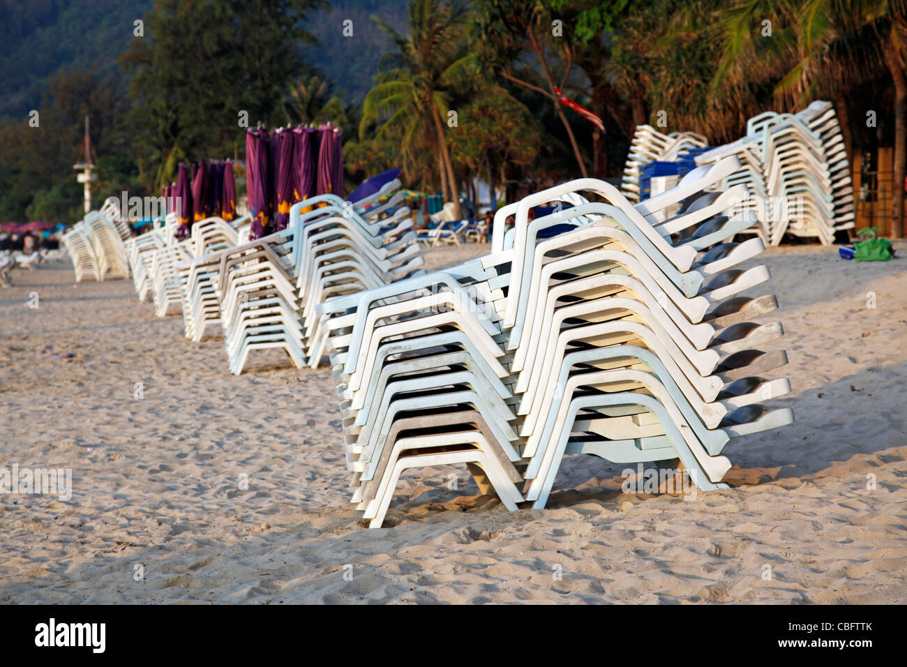 Holiday beach scene with sun loungers and umbrellas on sandy Patong ...