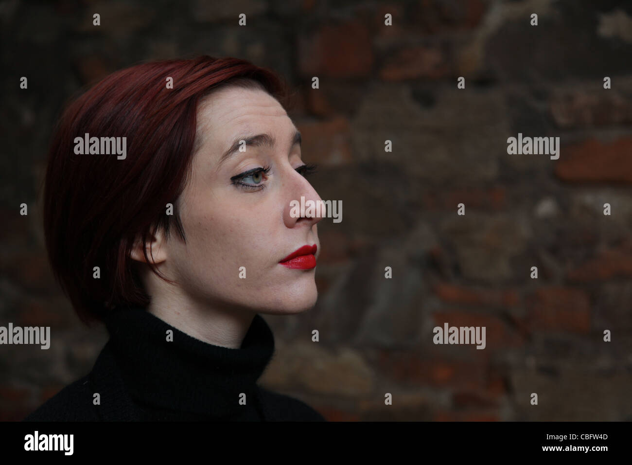 A young attractive woman's profile looking straight forward with a ...