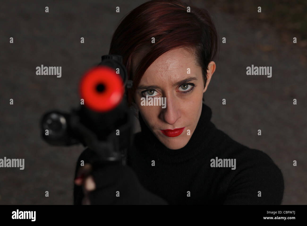 Woman pointing a gun hi-res stock photography and images - Alamy