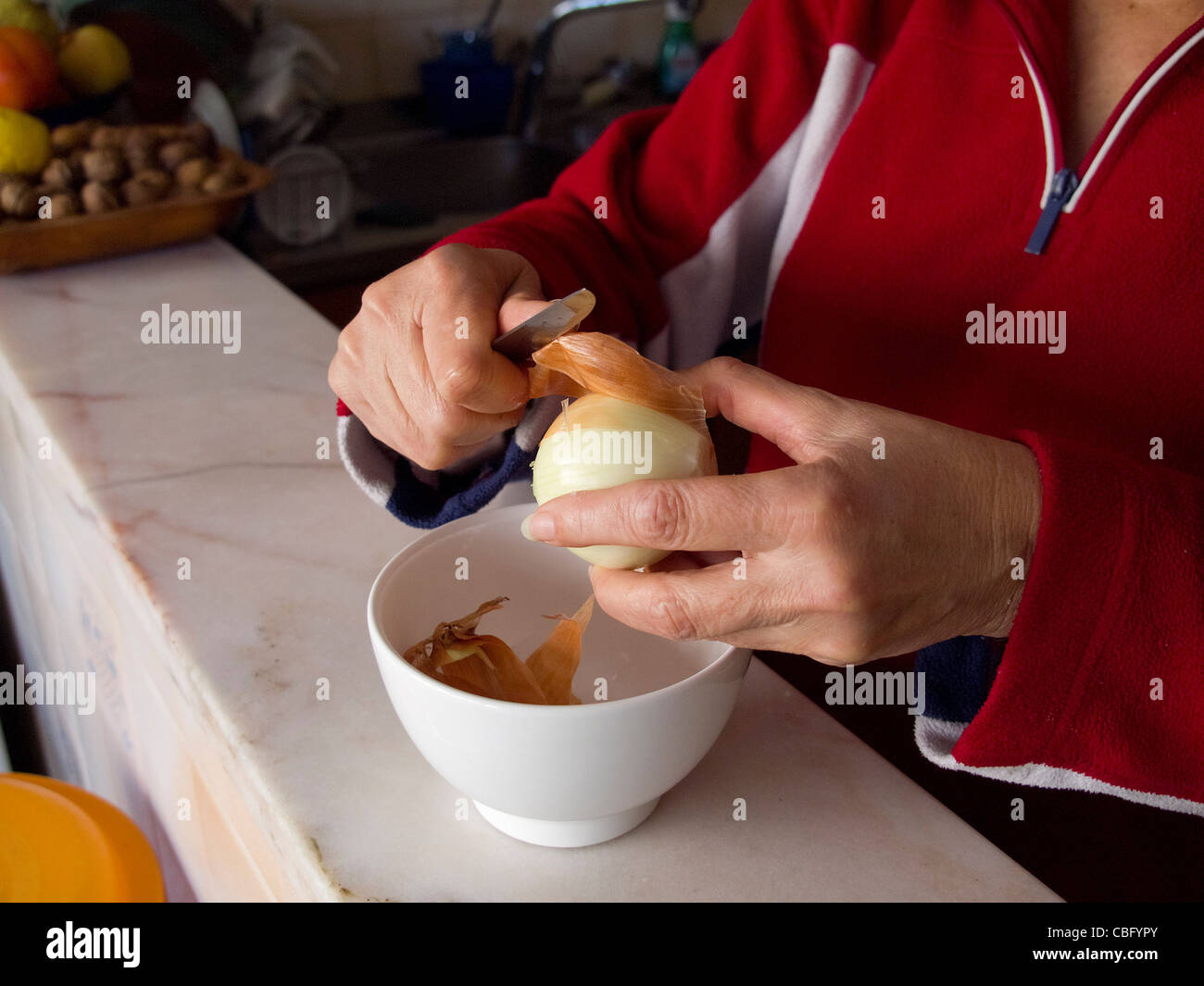 Woman peeling onion close up hi-res stock photography and images - Alamy