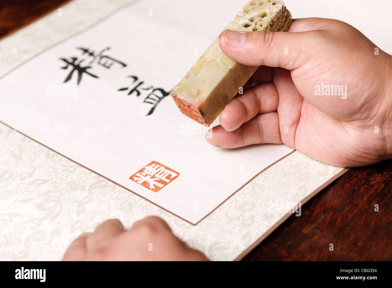 Calligrapher holding a stamp Stock Photo - Alamy