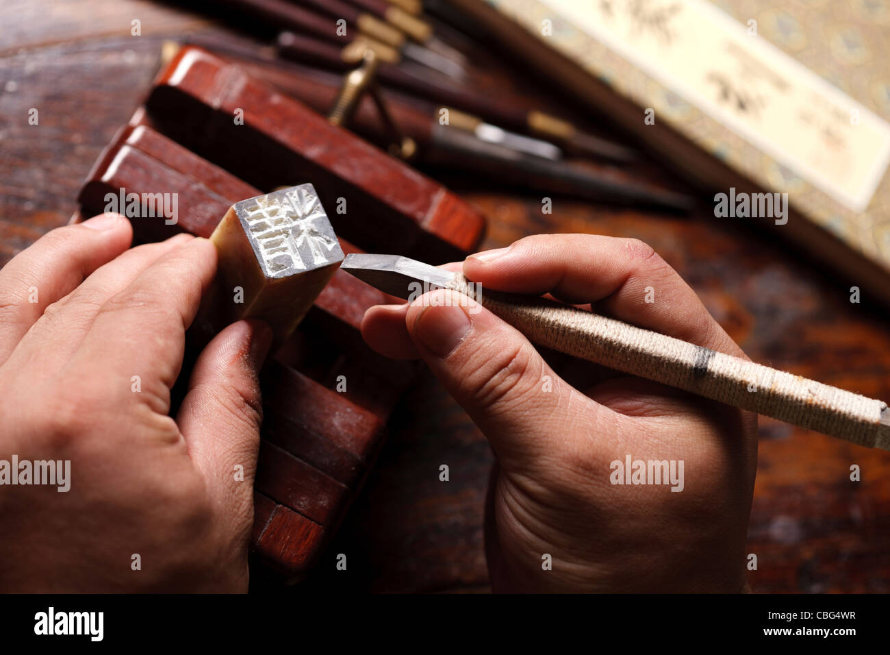 Craftsman carving Chinese character into a Chinese chop Stock Photo - Alamy