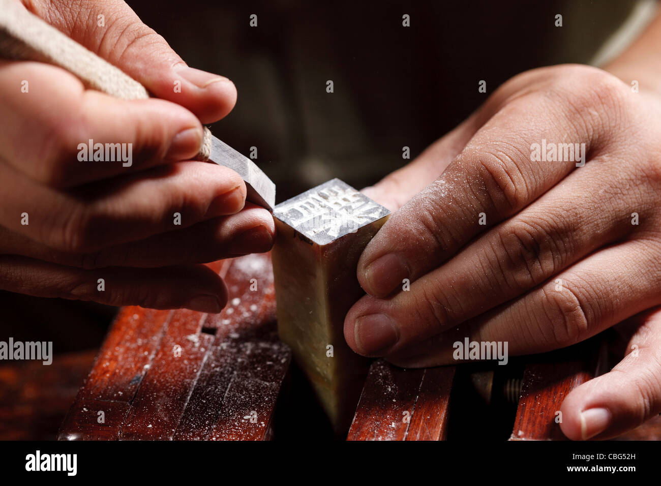 Craftsman carving Chinese character into a Chinese chop Stock Photo - Alamy