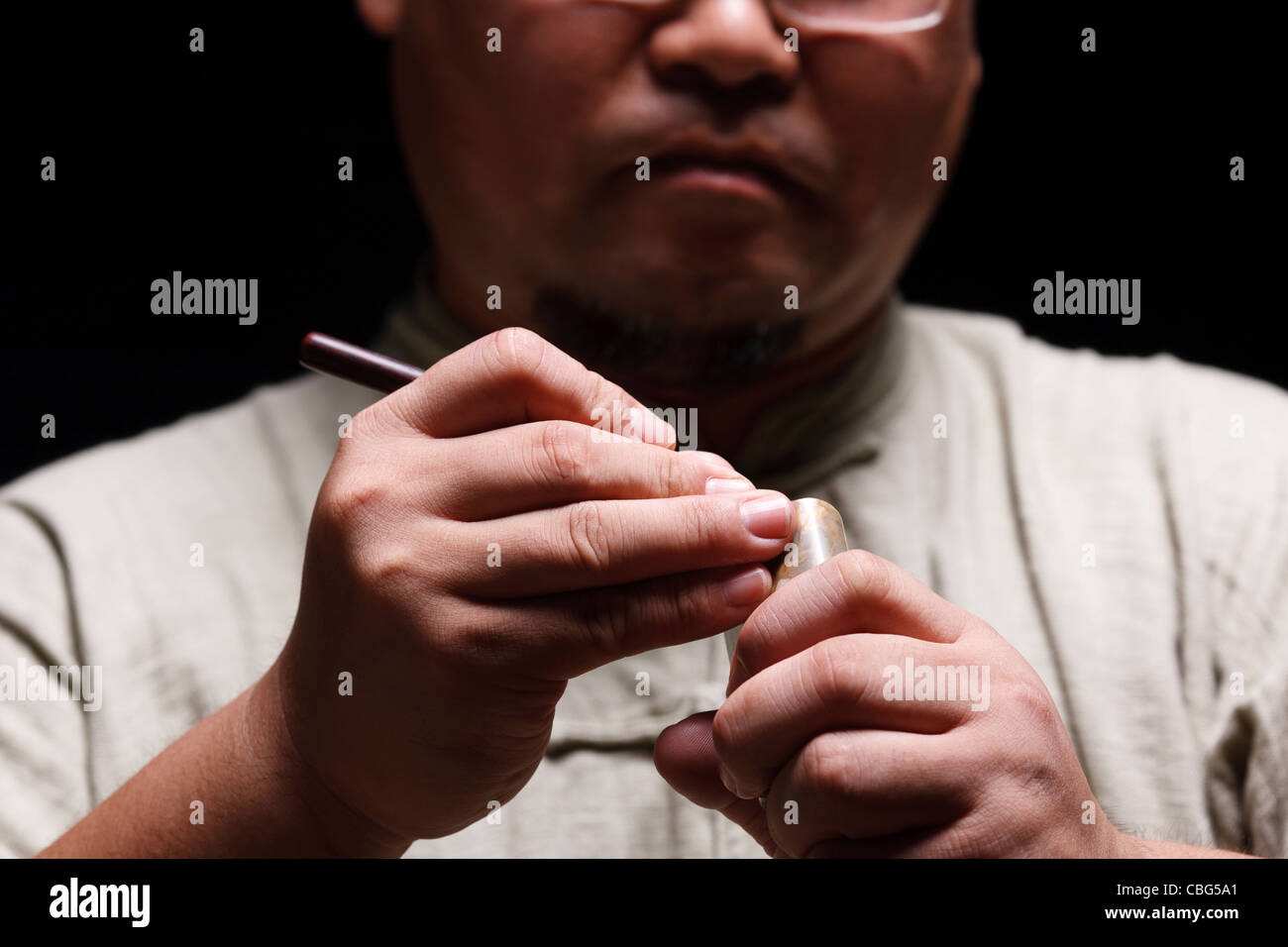 Craftsman carving Chinese character into a Chinese chop Stock Photo - Alamy