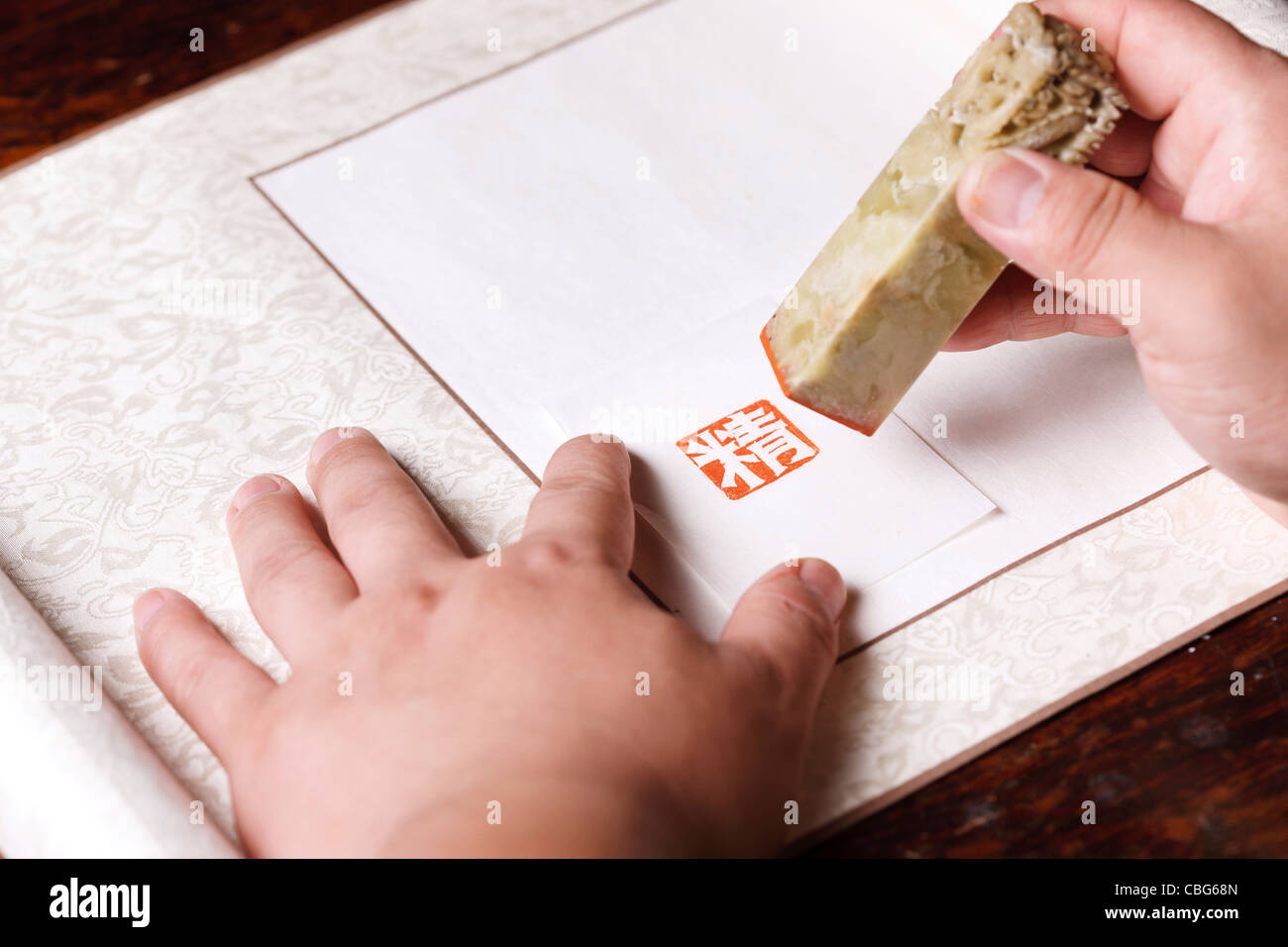 Calligrapher holding a stamp Stock Photo - Alamy