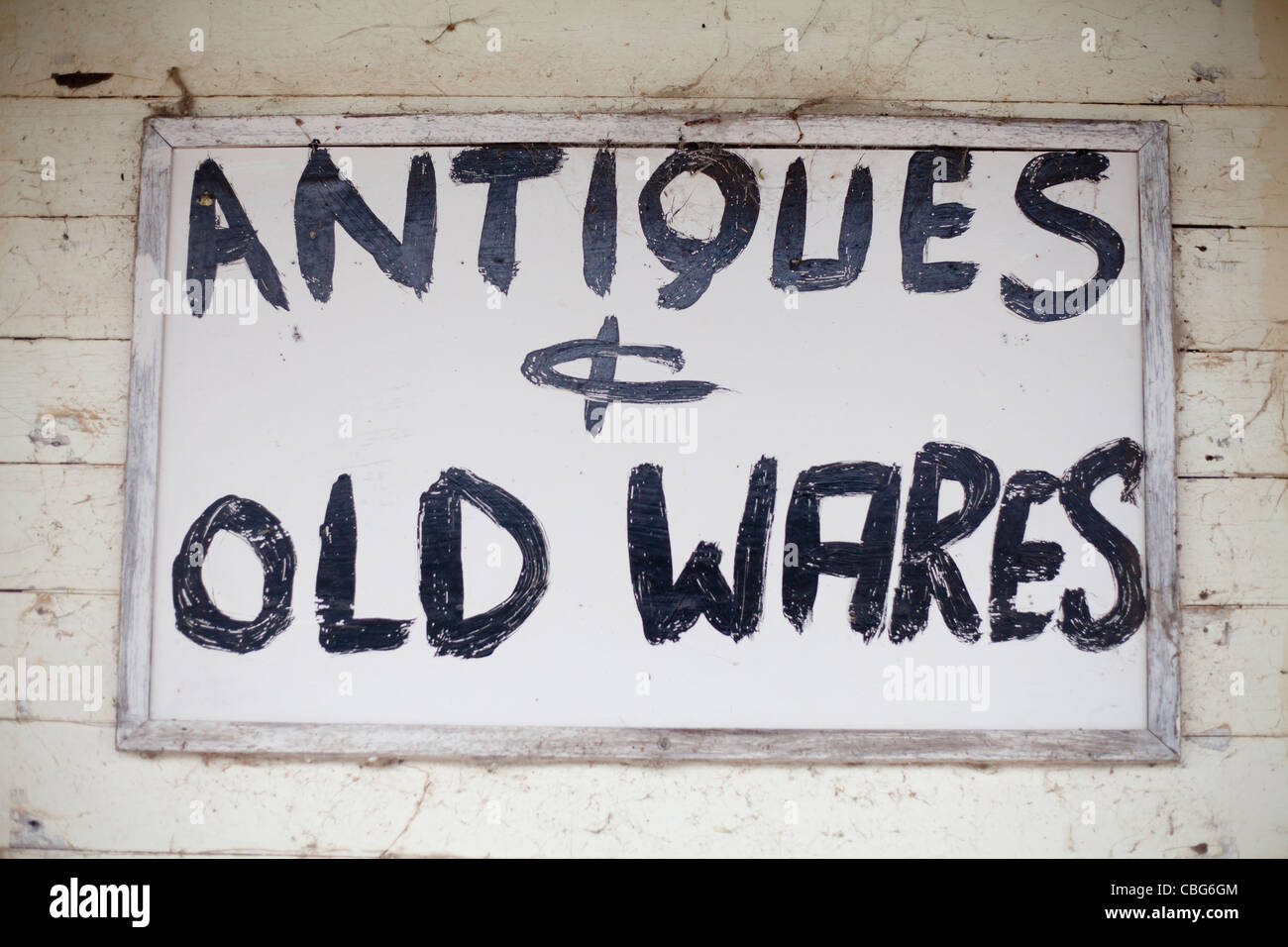 A wooden 'Antiques and old wares' sign post Stock Photo - Alamy
