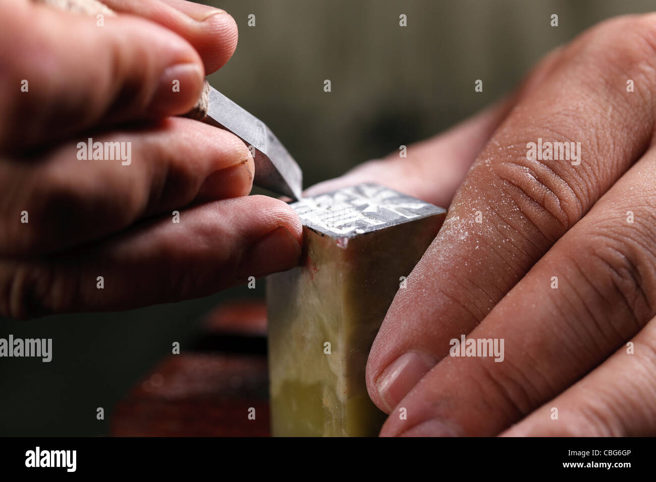 Craftsman carving Chinese character into a Chinese chop Stock Photo - Alamy