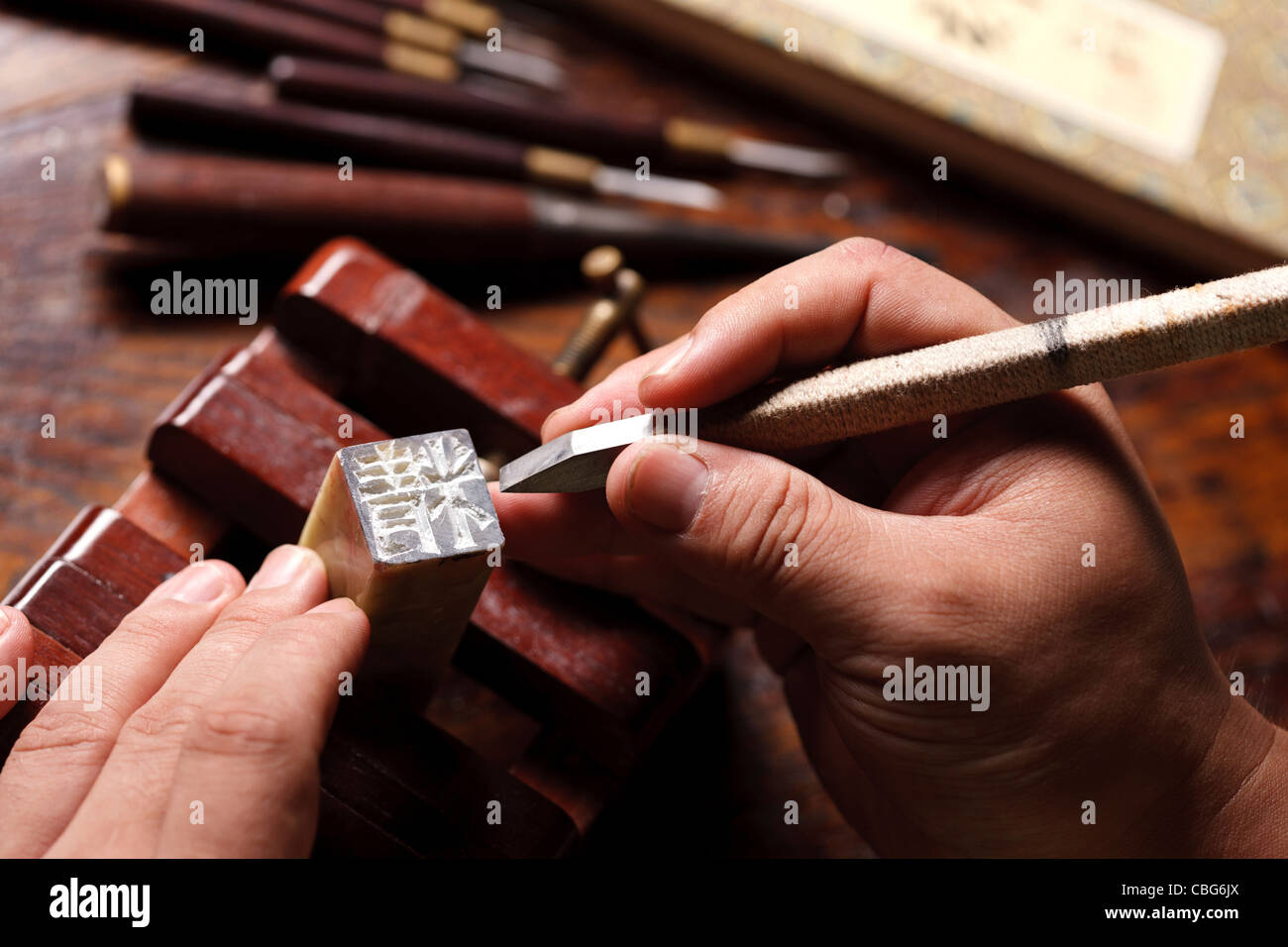 Craftsman carving Chinese character into a Chinese chop Stock Photo - Alamy