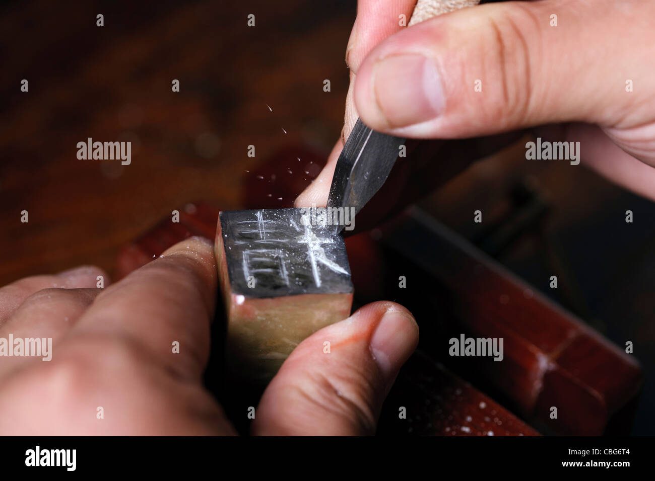 Craftsman carving Chinese character into a Chinese chop Stock Photo - Alamy