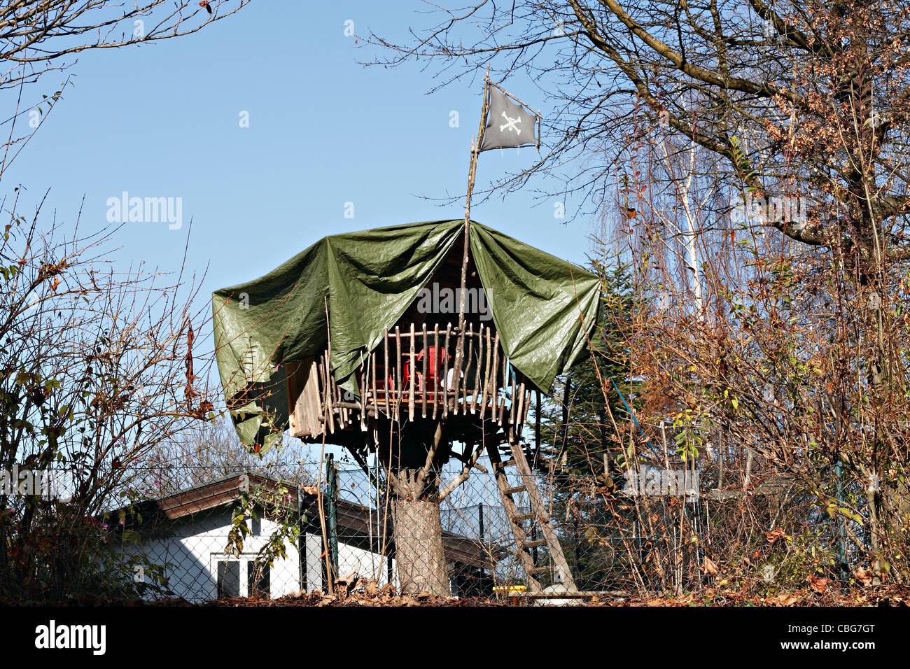 A large tree house with a skull and cross bones flag, Chiemgau Upper ...