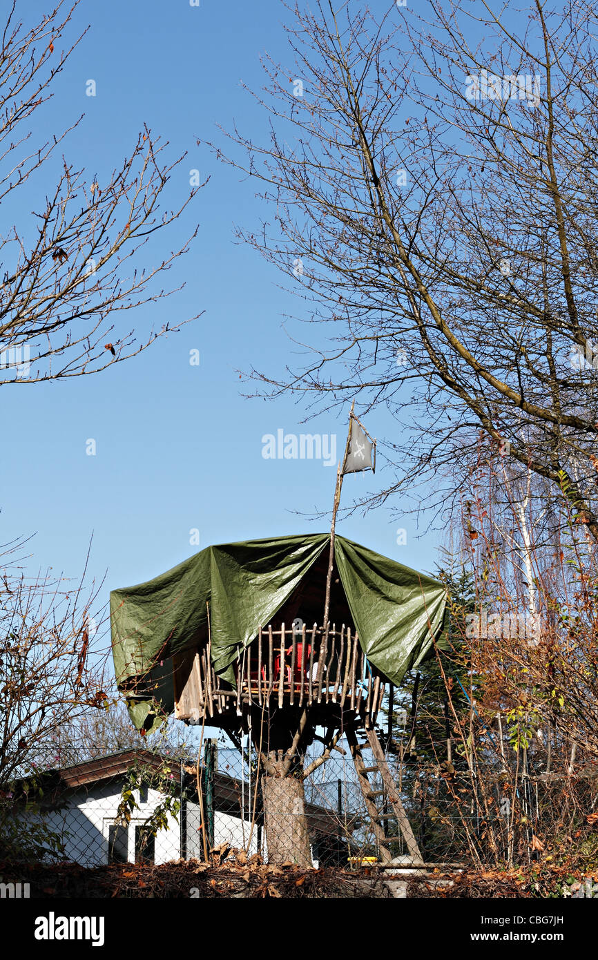 A large tree house with a skull and cross bones flag, Chiemgau Upper ...