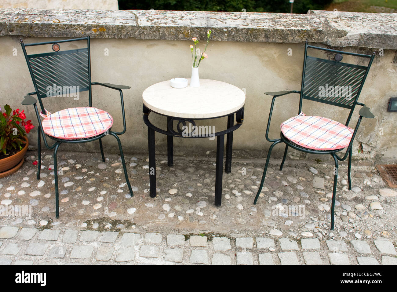 Two empty chairs and small table with decoration Stock Photo - Alamy