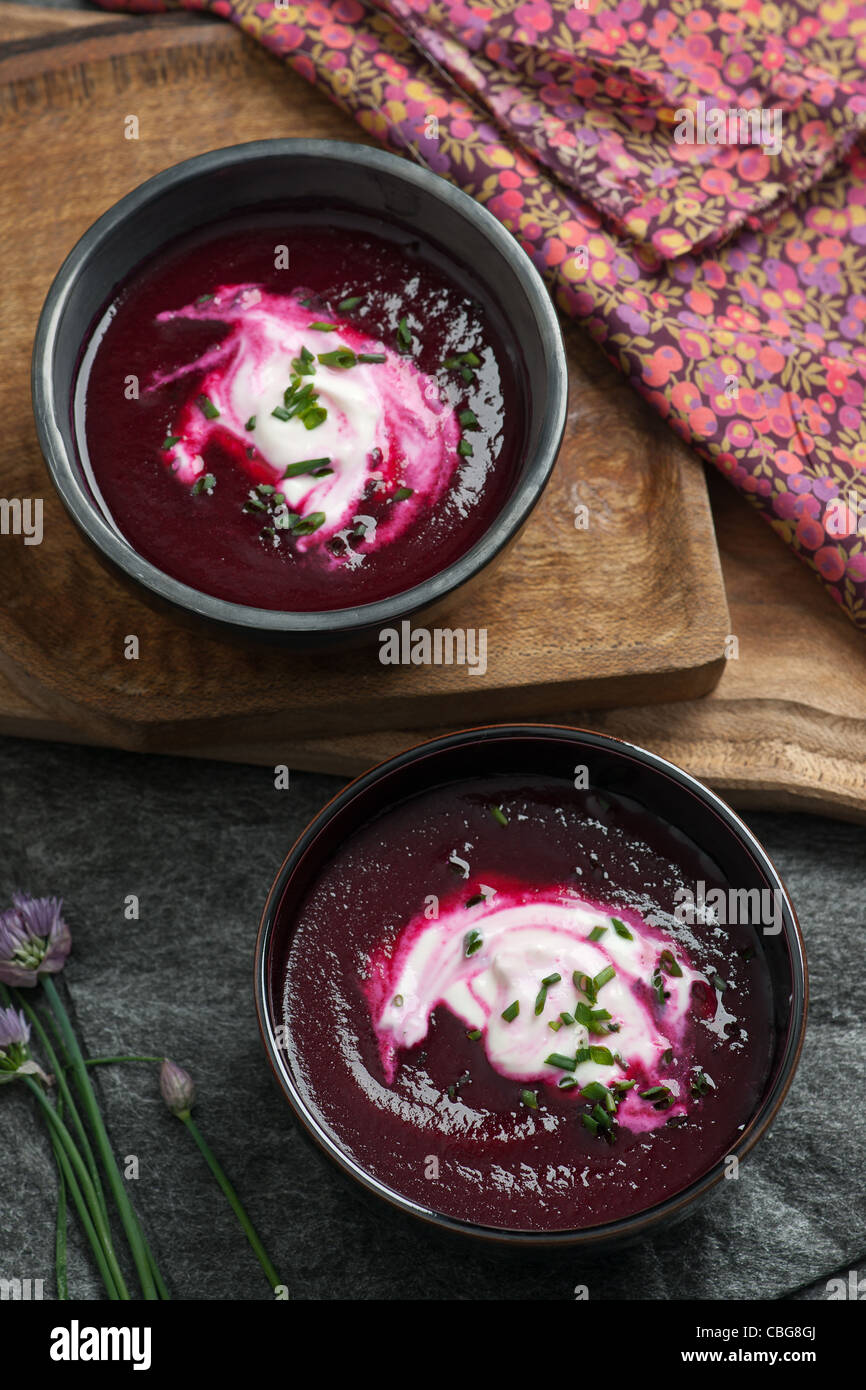 two bowls of beetroot soup with cream and fresh chive Stock Photo - Alamy