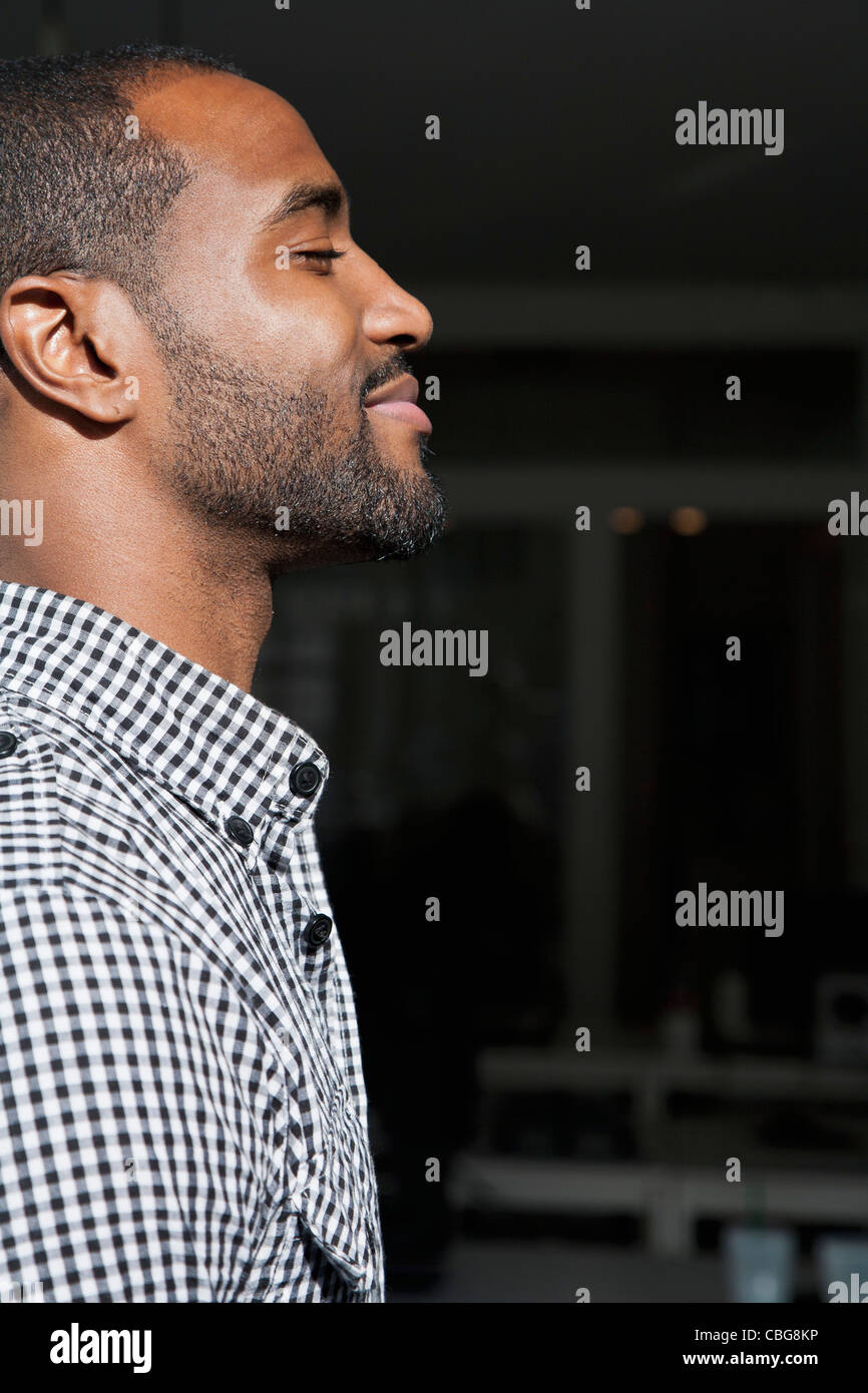 Side view of a man with his eyes closed and smiling Stock Photo - Alamy