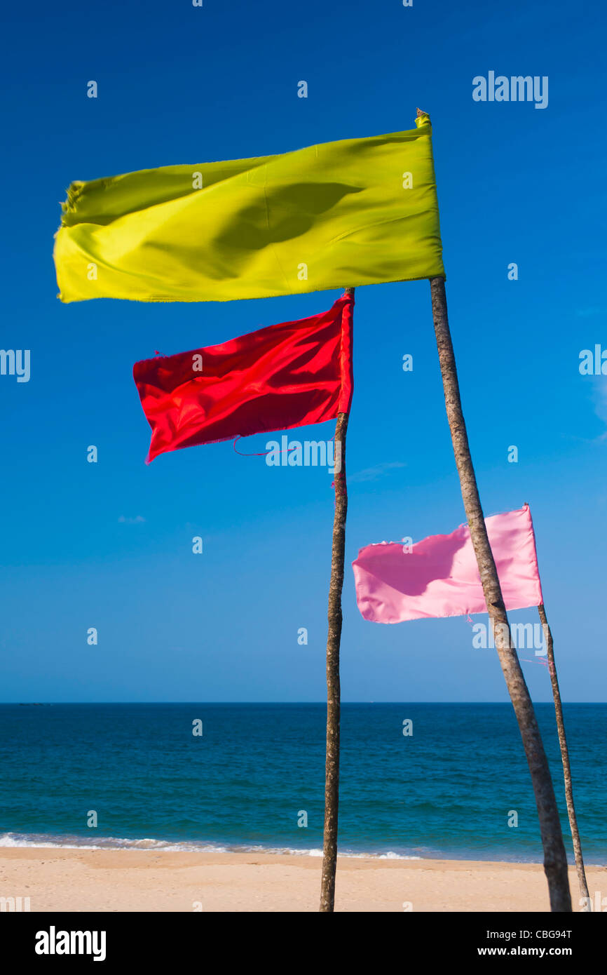 Colored flags flapping in the wind on a beach Stock Photo - Alamy