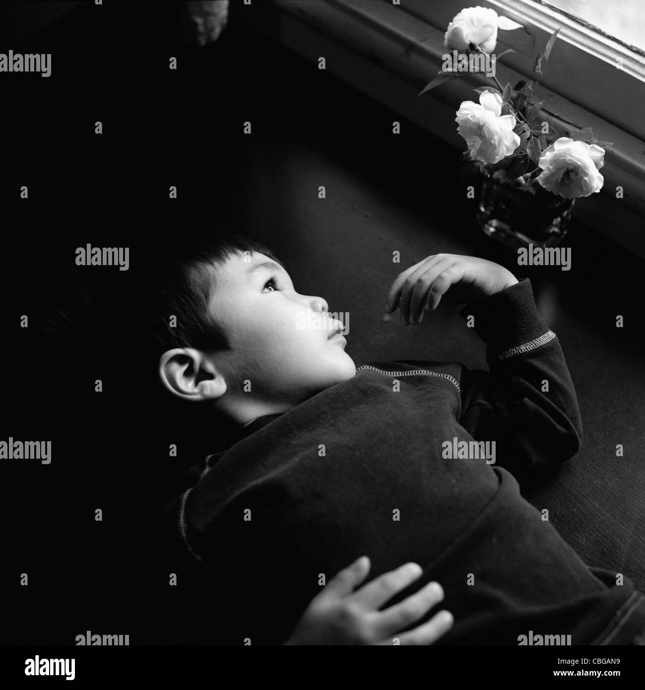 Boy lying under Black and White Stock Photos & Images - Alamy