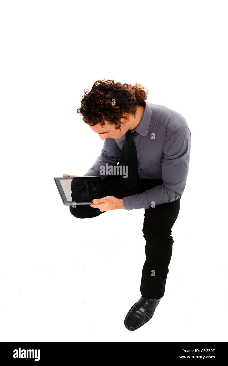 Portrait of a businessman with a tablet computer against a white ...