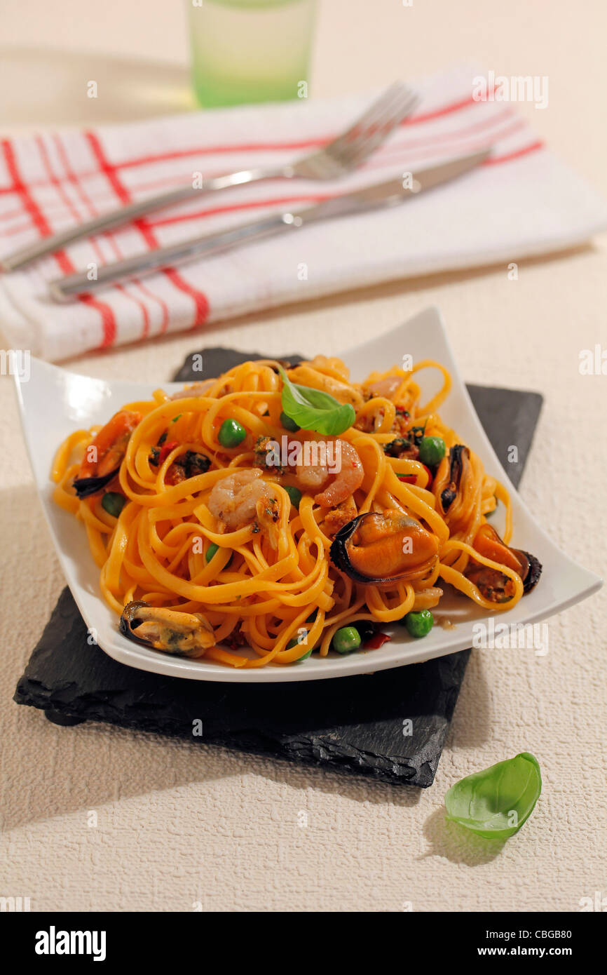 Orange spaghetti with mussels and prawns. Recipe available Stock Photo ...