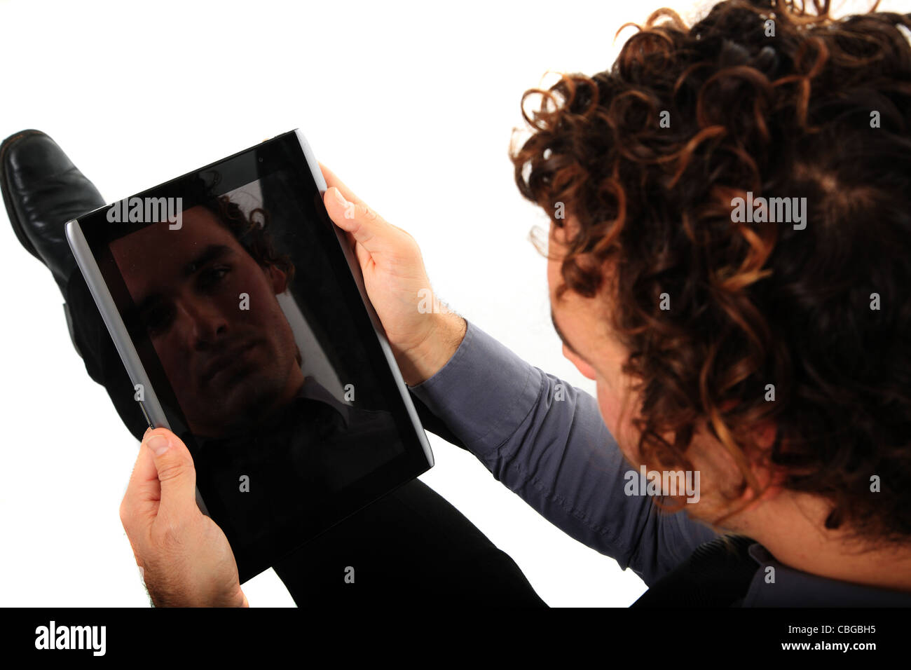 Portrait of a businessman with a tablet computer against a white ...