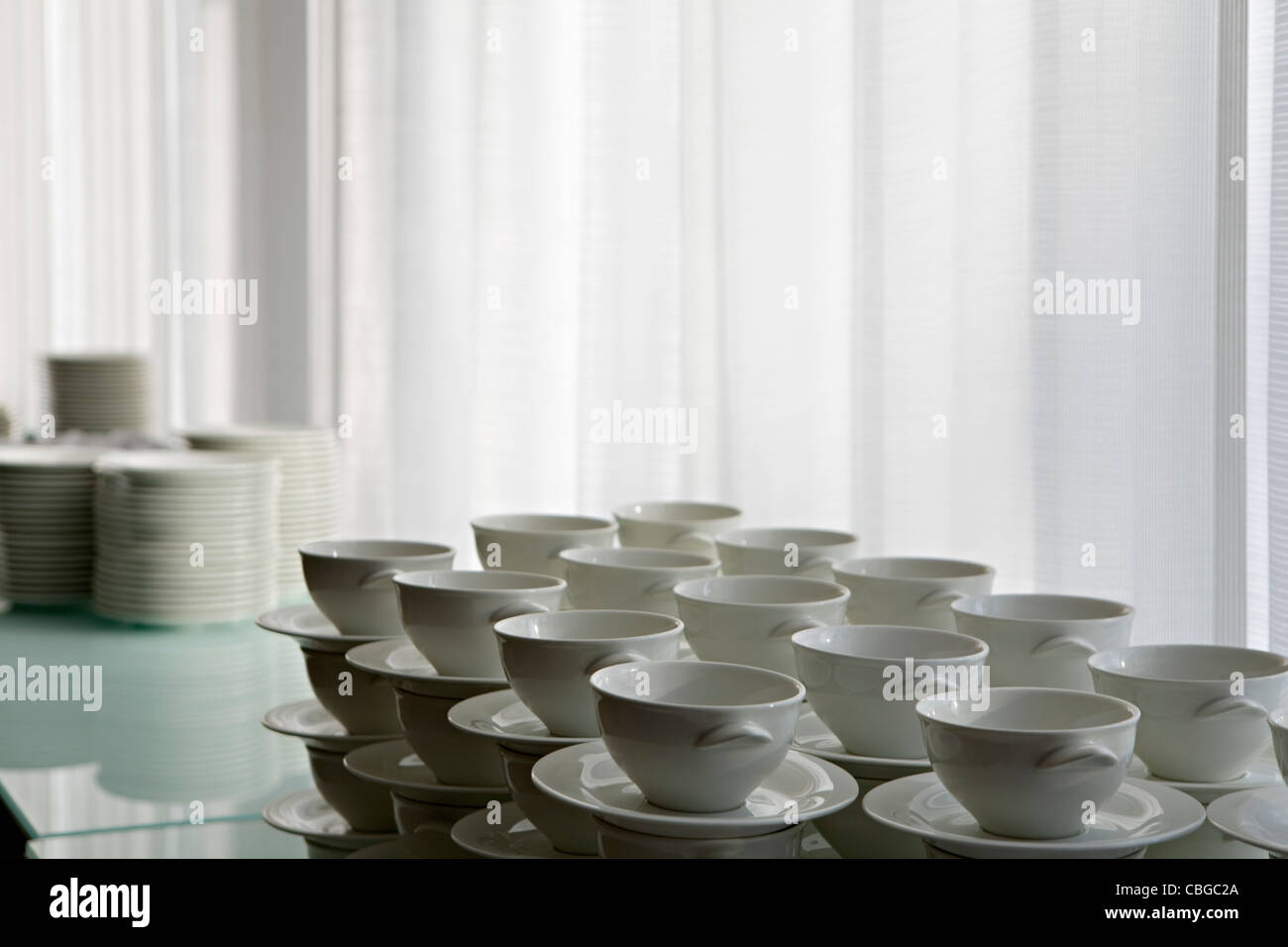 Stacks of cups and saucers Stock Photo - Alamy