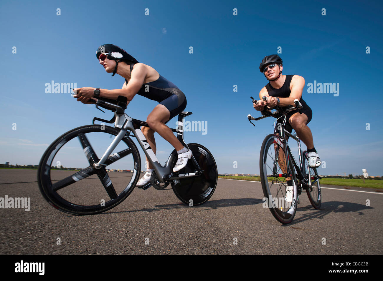 Two cyclists on racing bicycles, side view, low angle view Stock Photo ...