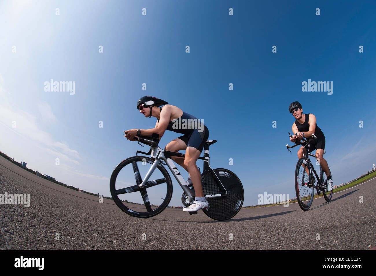 Two cyclists on racing bicycles, side view, low angle view Stock Photo ...