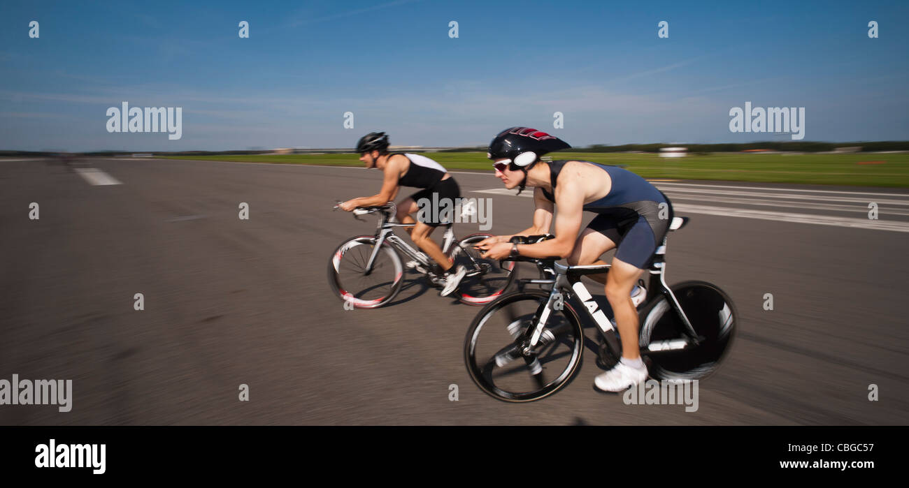 Two cyclists on racing bicycles, side view, low angle view Stock Photo ...