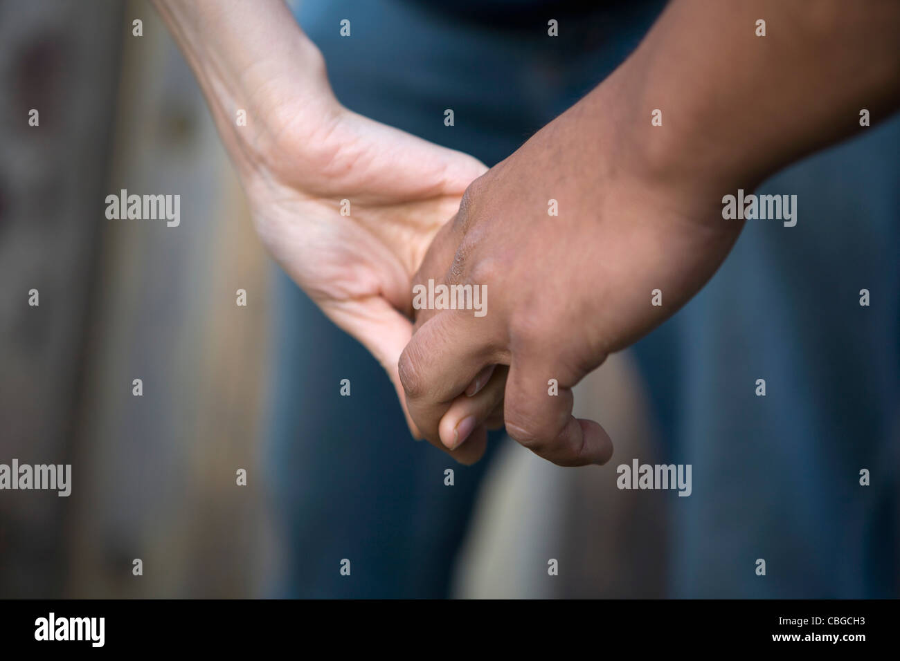 Two people holding hands Stock Photo - Alamy