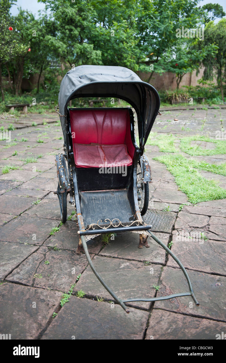 Empty Chinese rickshaw on paving stones Stock Photo - Alamy