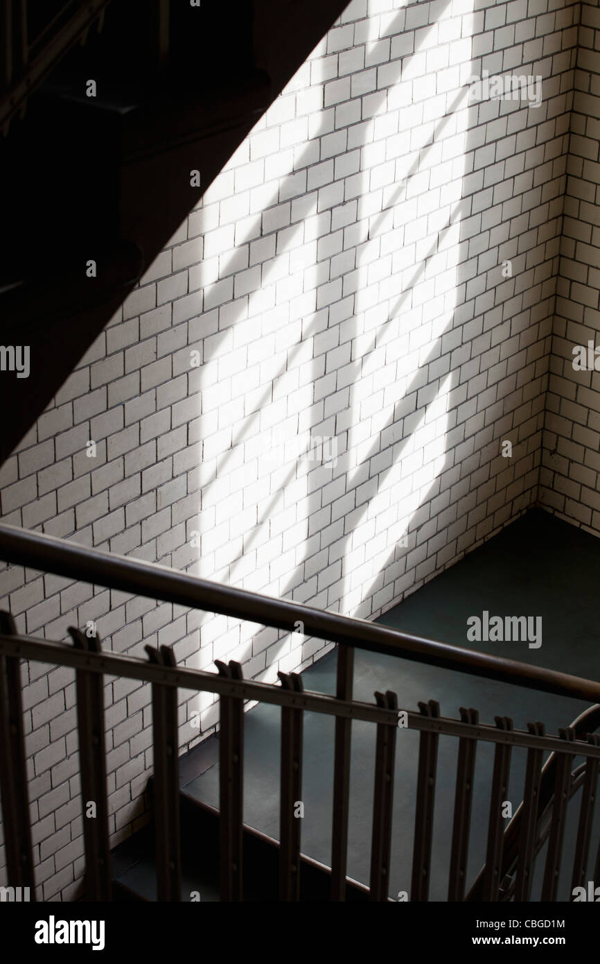 Light through window onto wall over staircase Stock Photo - Alamy
