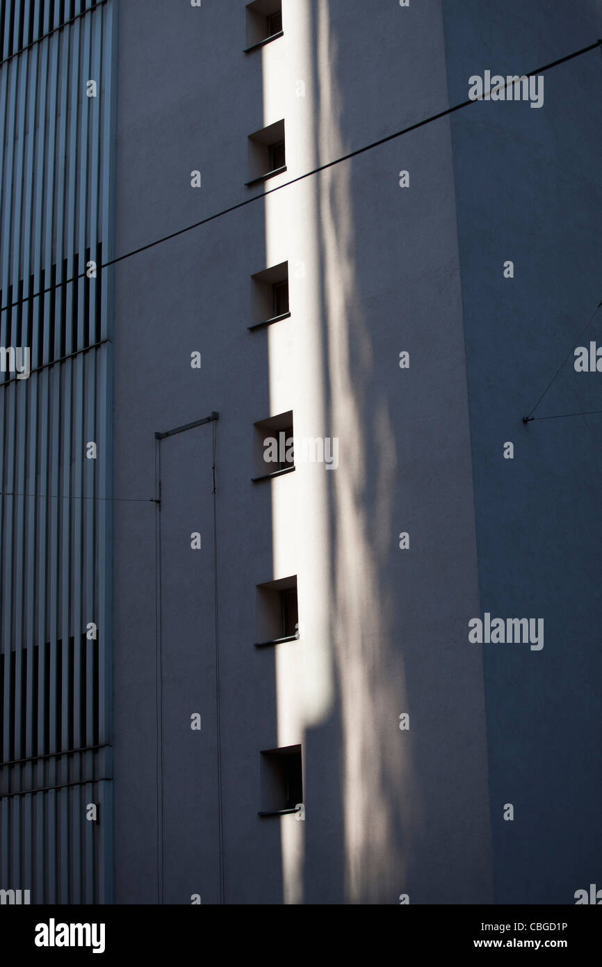 Reflection of light projected onto wall alongside a sequence of window ...
