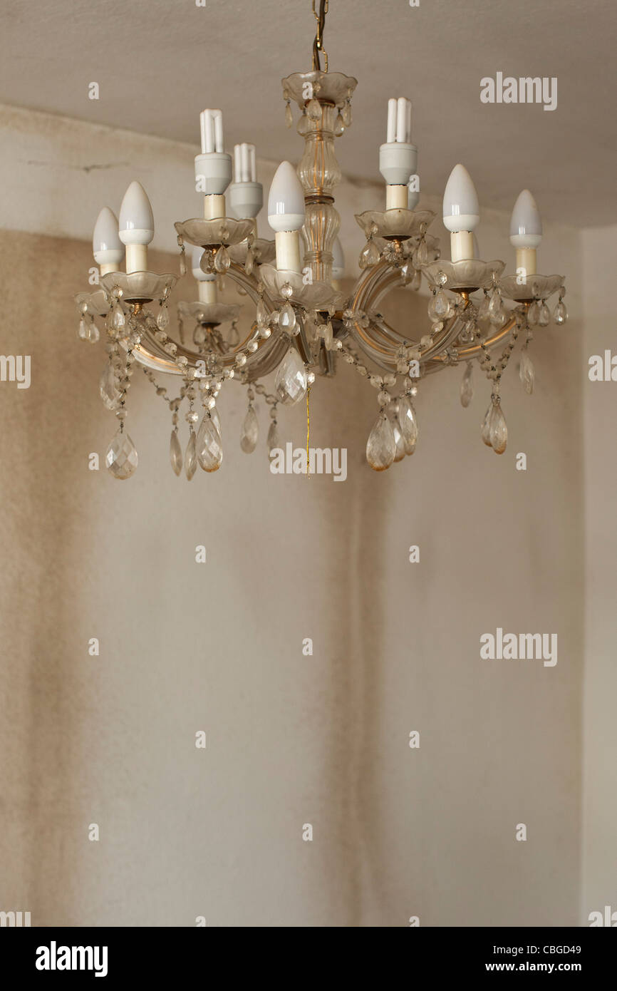 Old and dirty chandelier hanging in bare room Stock Photo - Alamy