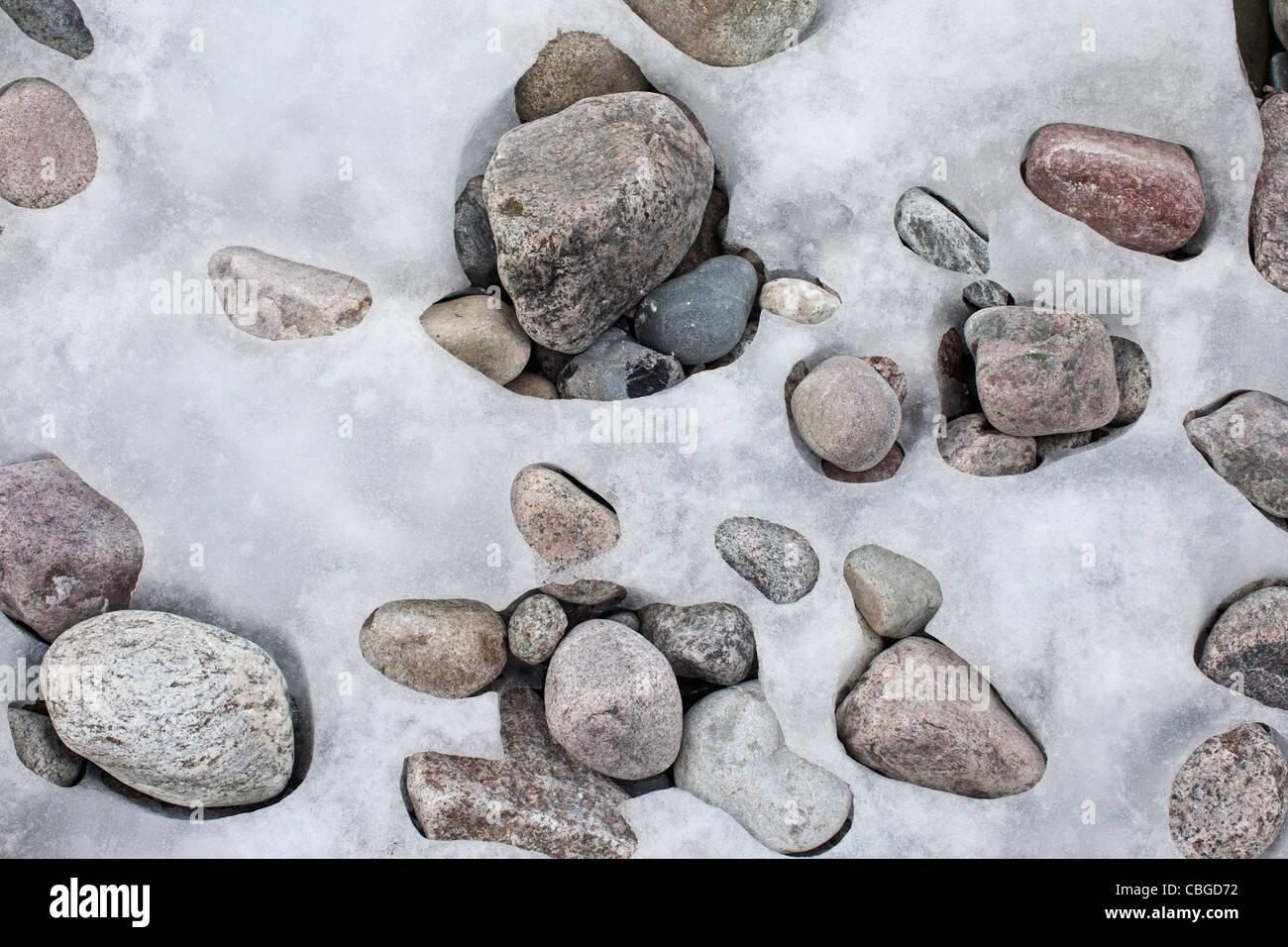 Patterns formed by ice over pebbles Stock Photo - Alamy