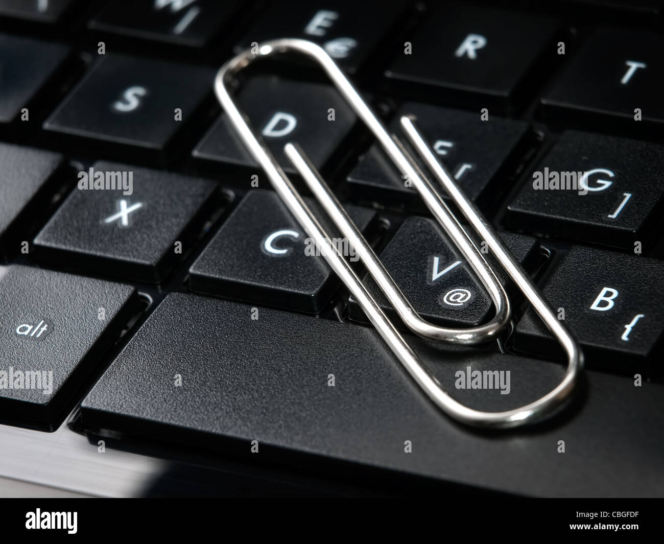Paper clip on the keyboard as a metaphor about sending an attachment in ...