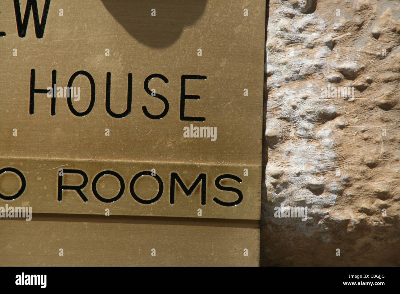 brass guest house rooms hotel sign outdoors in sun Stock Photo - Alamy