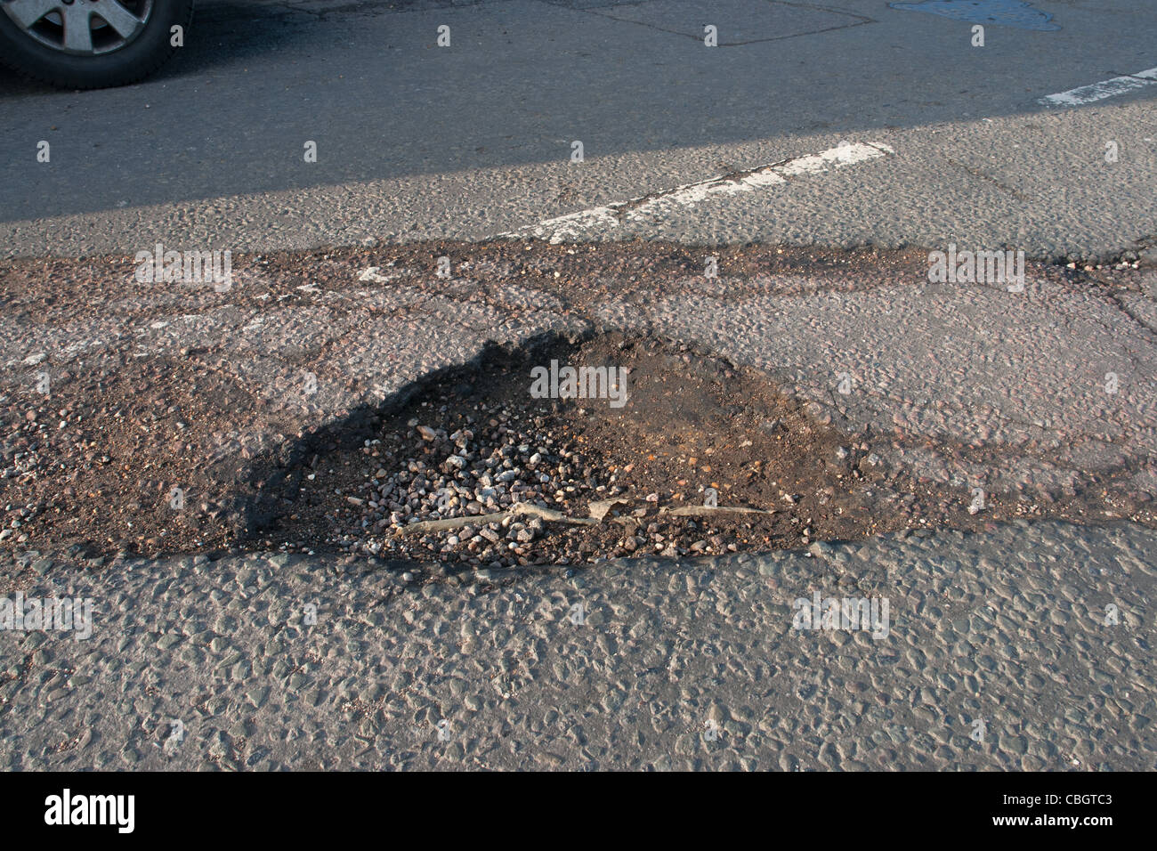 Pothole in the road Stock Photo - Alamy