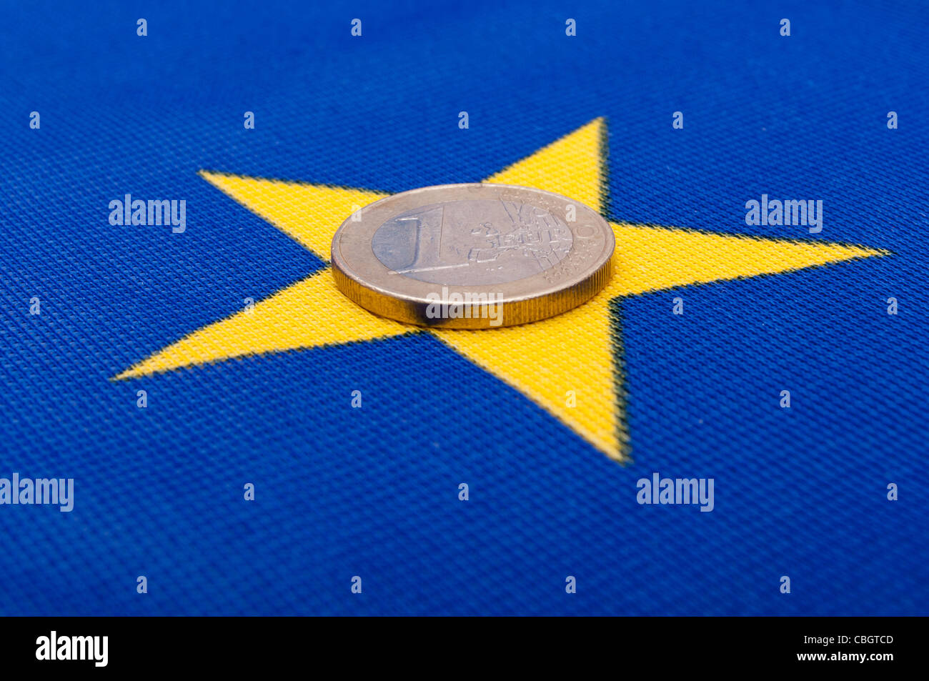 One Euro Coin on Blue Flag of European Union Stock Photo - Alamy