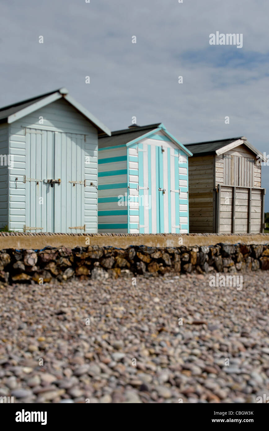 colourful wooden beach huts along the seafront at Budleigh Salterton ...