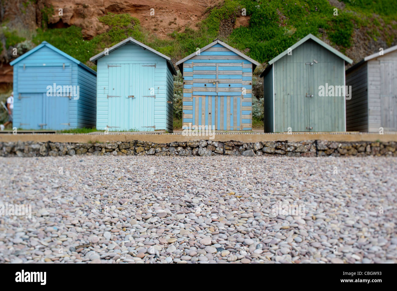 colourful wooden beach huts along the seafront at Budleigh Salterton ...