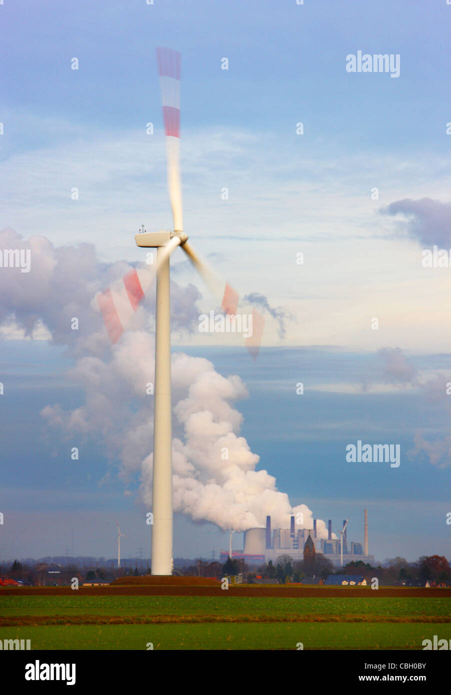 Wind power plant. Wind energy. Brown coal power station in the back ...