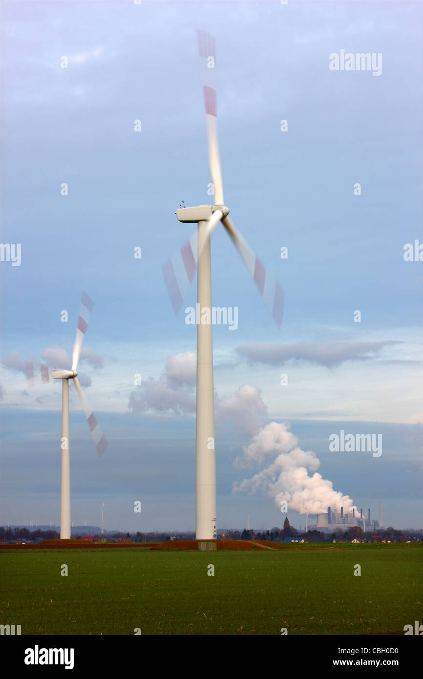 Wind power plant. Wind energy. Brown coal power station in the back ...