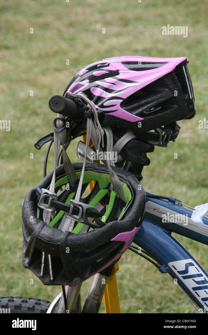 two helmets on mountain bike in park Stock Photo - Alamy