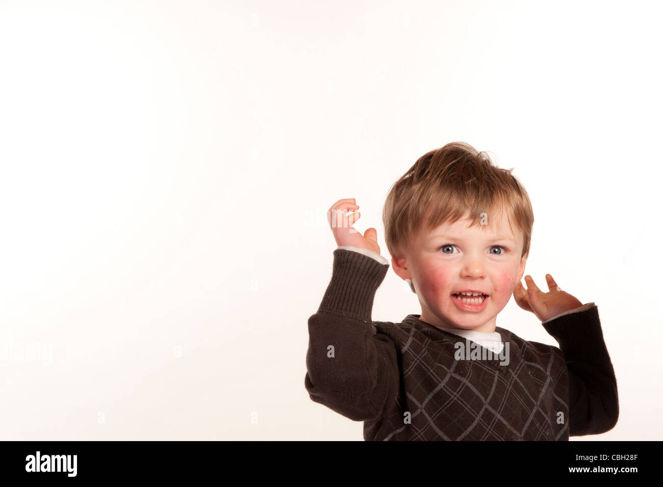 cute little boy throwing up arms in glee Stock Photo - Alamy