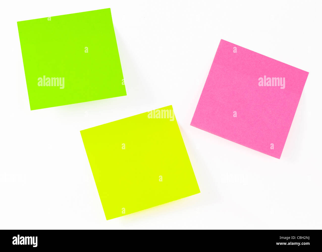 three color sticky notes on a white background Stock Photo - Alamy