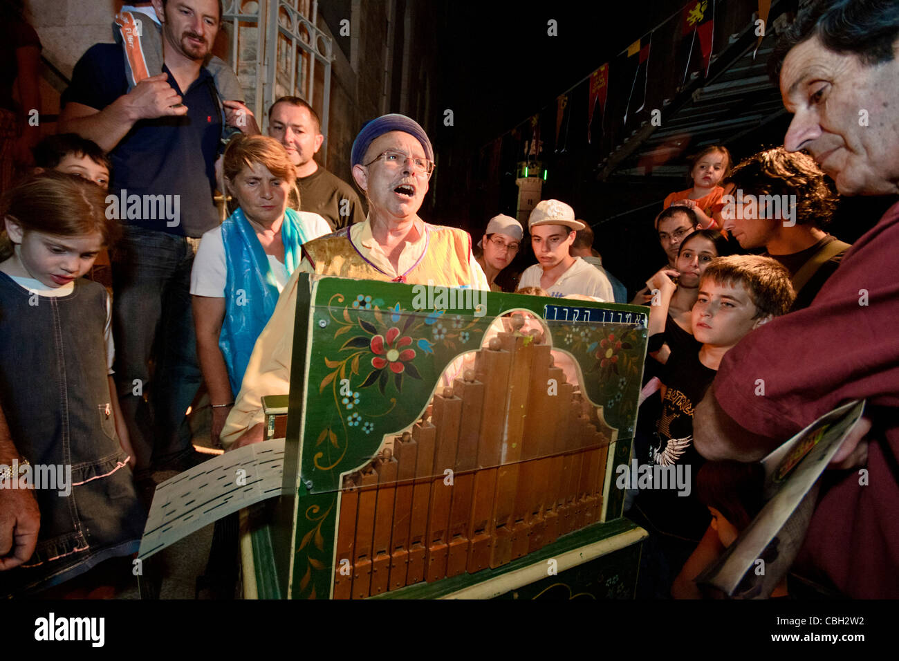 Old City, Jerusalem, Israel. A man sings and operates a music box ...