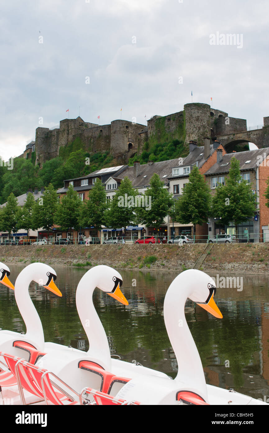 Bouillon, Belgium. Swan-shaped boats on the river; the town and fort ...