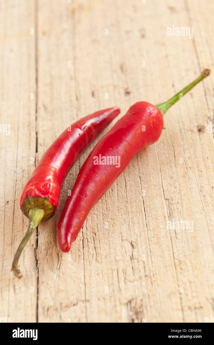Red hot chili peppers on a rustic wooden background Stock Photo - Alamy