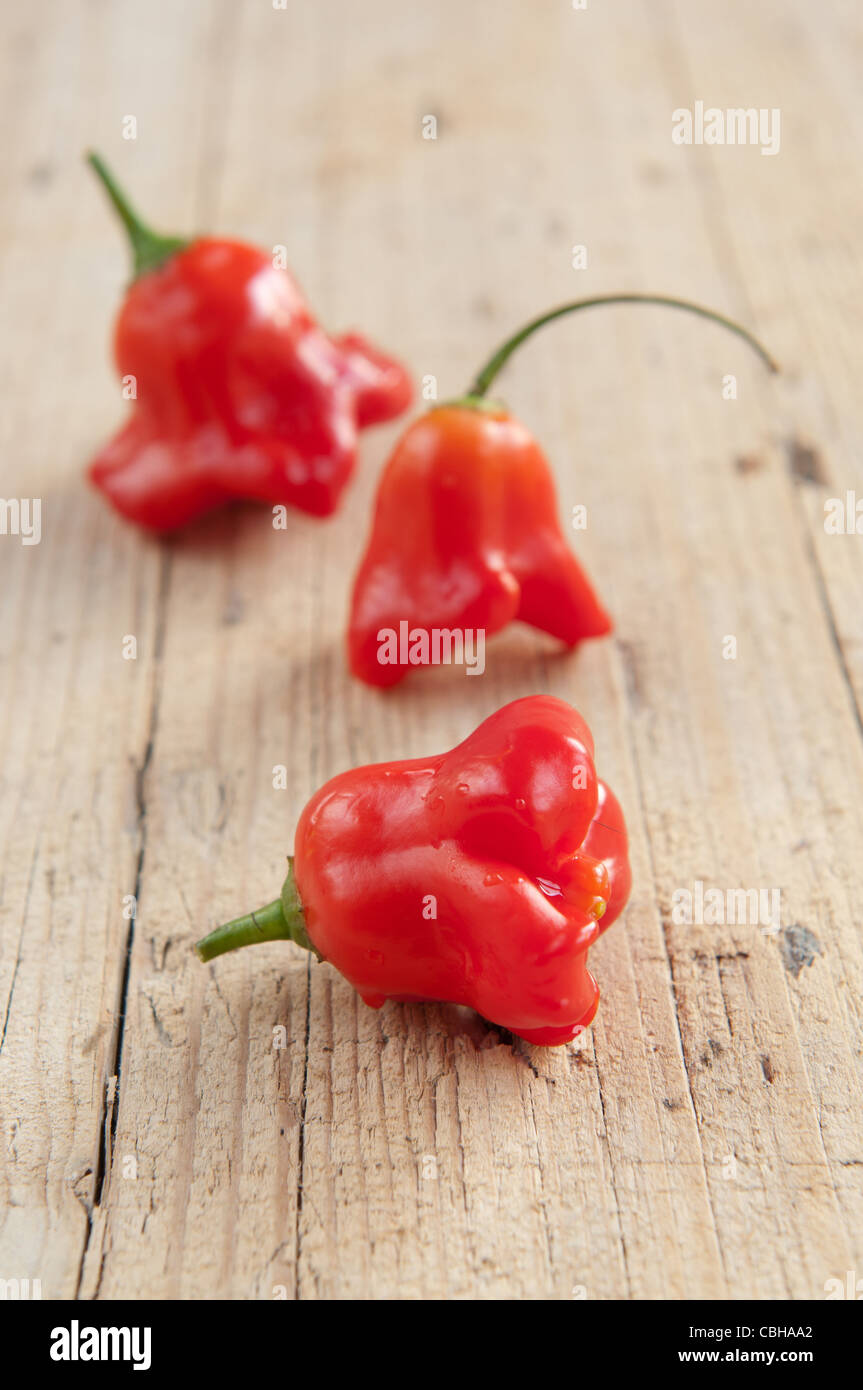 Red hot chili peppers on a rustic wooden background Stock Photo - Alamy