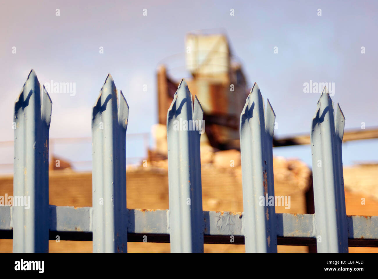 Looking at an industrial site through a sharp metal fence Stock Photo ...
