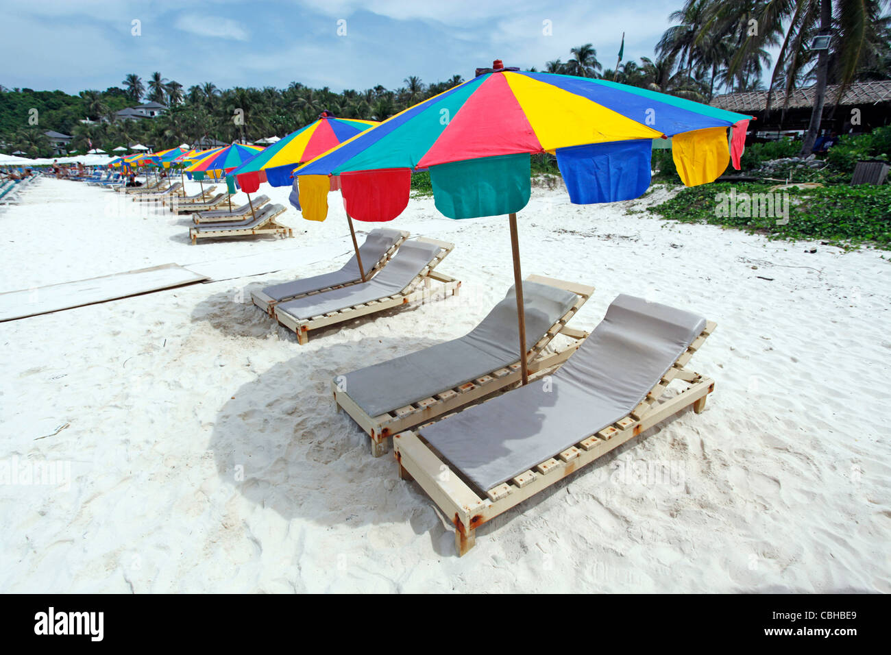 Sun loungers and beach umbrellas on the sandy holiday beaches of Patok ...